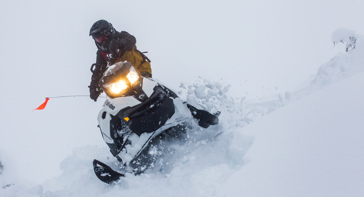Backcountry Snowmobile Tours: Powder Surfing on a Storm Day